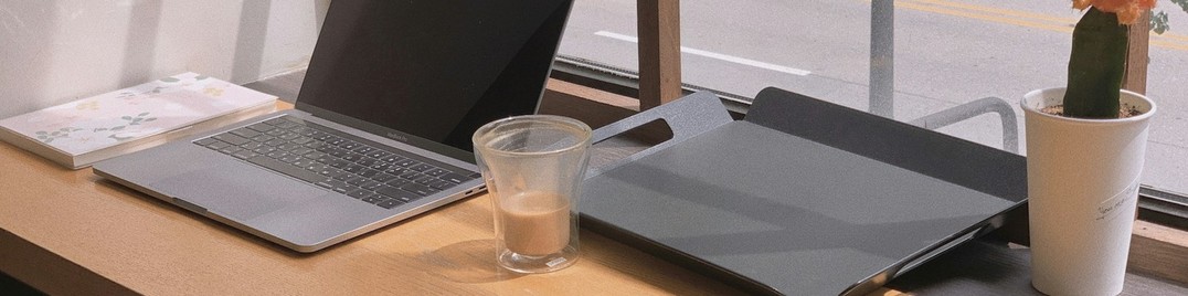 Overlapping Laptops On The Table | LinkedIn Background